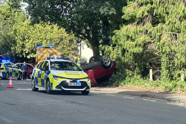 Emergency presence as car overturns after crash in Ferndown