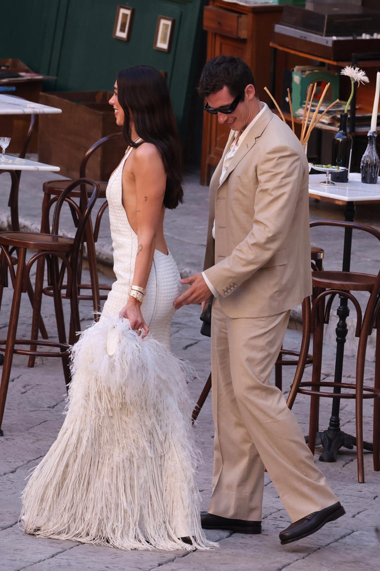 Dua Lipa kicks off her wedding weekend with white leather, feathers and ...