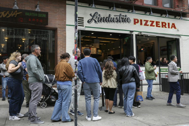 In New York, waiting in line becomes a social scene