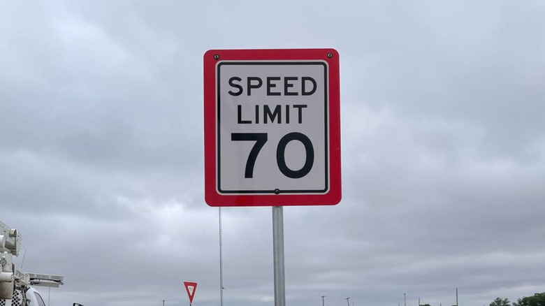 Why do some speed limit signs have a red border?