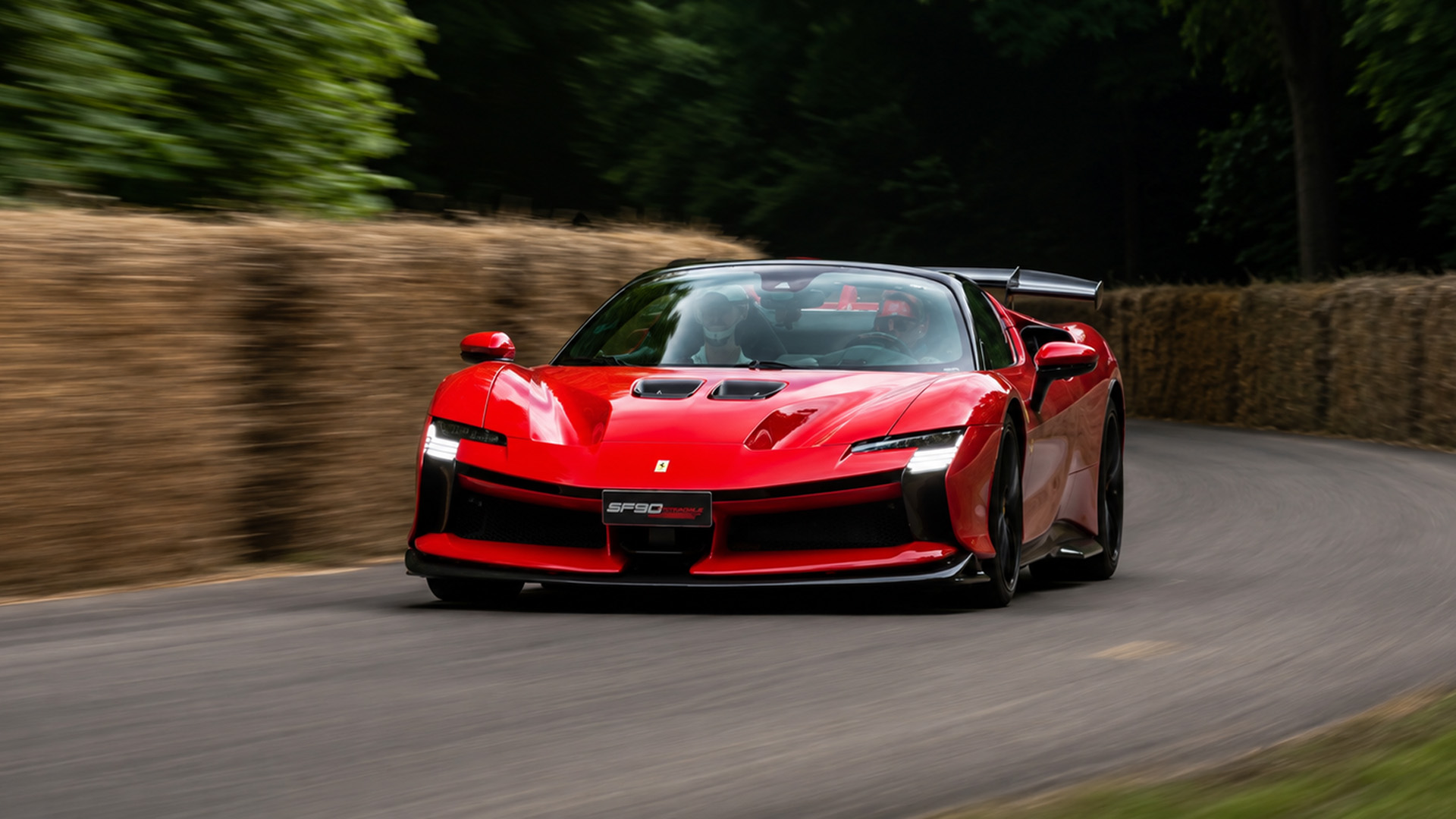 Red Ferrari SF90 XX charges hard through track corner