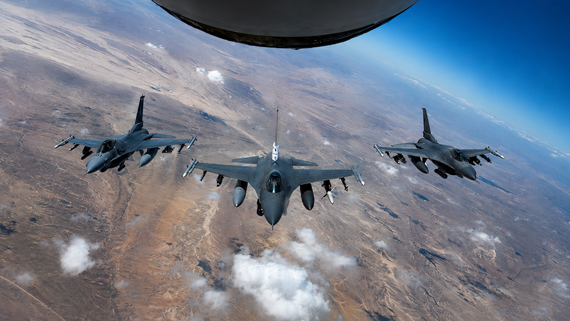 Three F-16 fighter jets fly over the Middle East