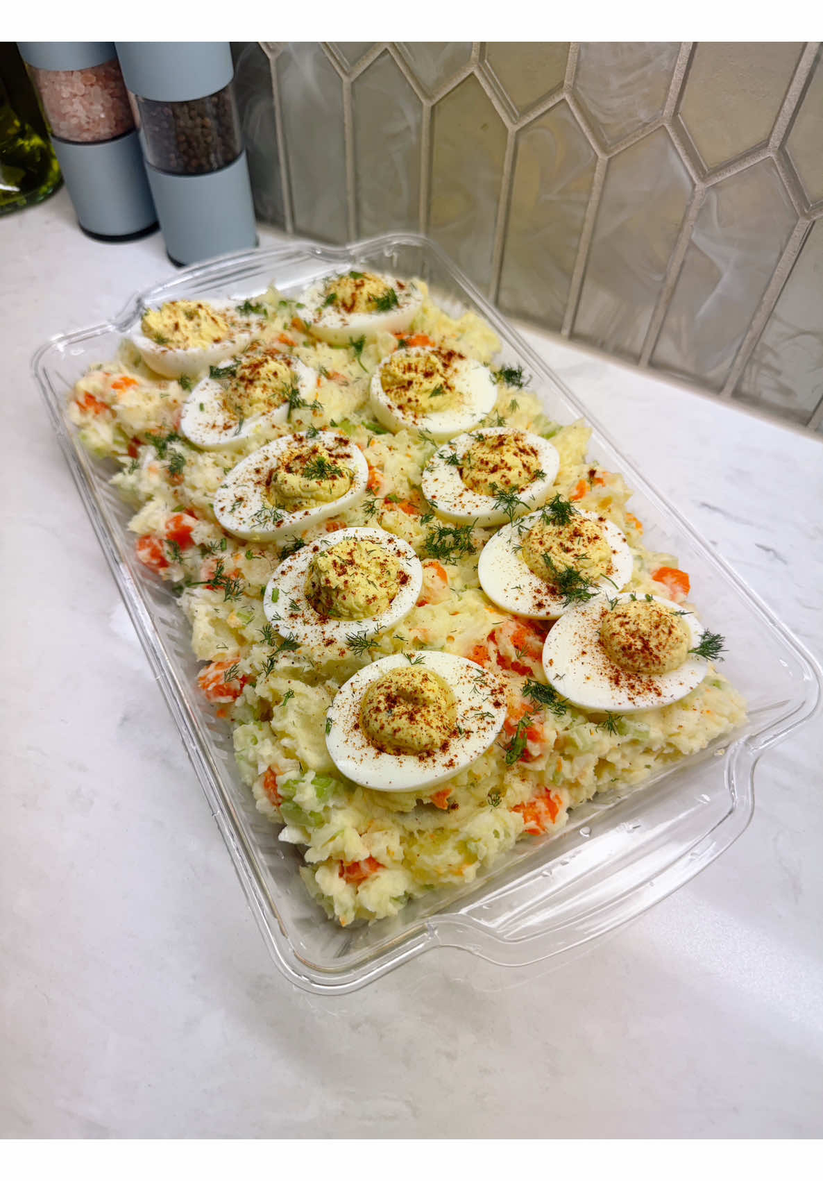 A classic creamy potato salad with deviled eggs, paprika, and dill on a ...