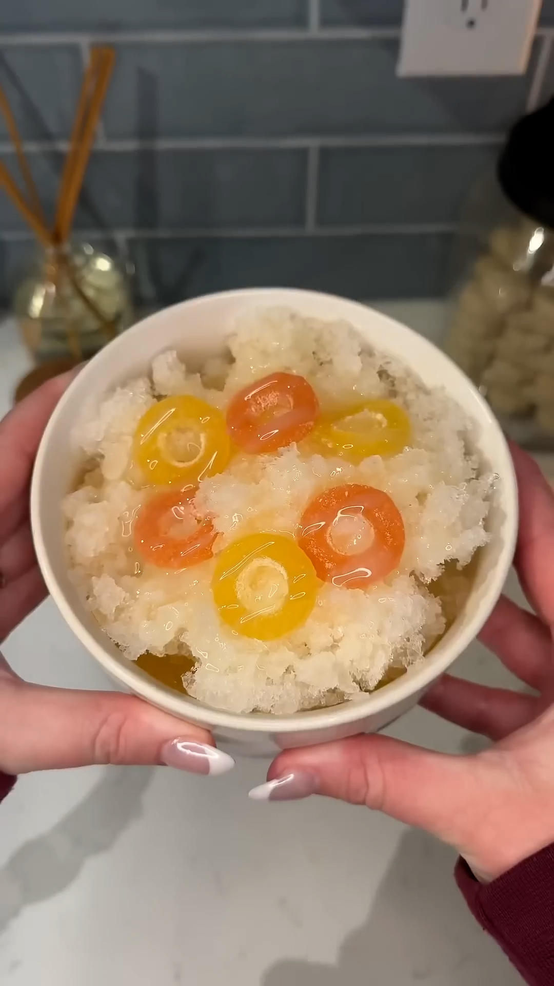 Sweet peach syrup poured over a mound of fluffy shaved ice at home