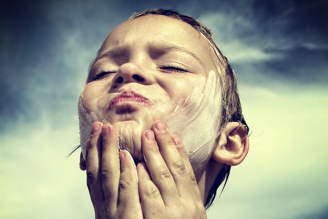How do the chemicals in sunscreen protect our skin from damage?