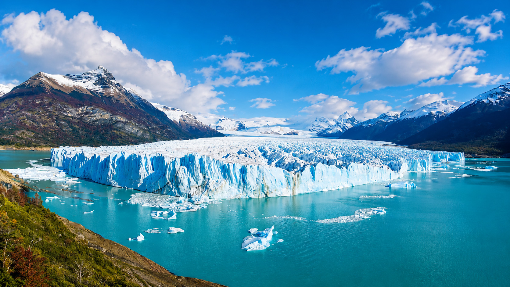 A massive glacier towering above vivid turquoise waters