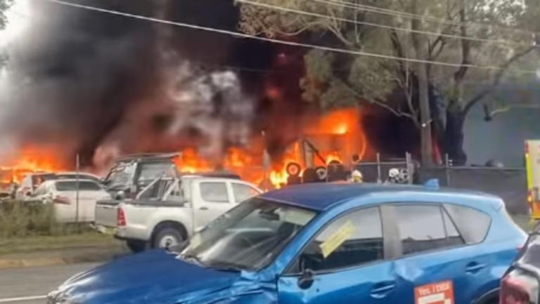 Horror moment tyre shop engulfed in flames