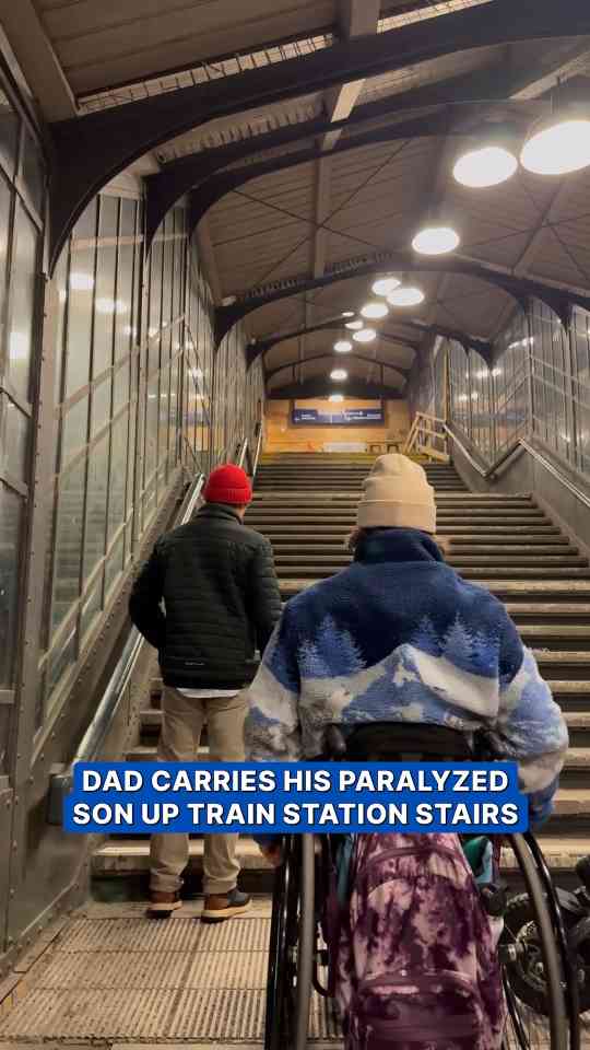 Father carries paralyzed son up station stairs after elevator failure