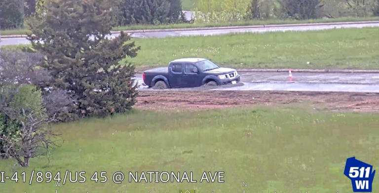 Watch: Wisconsin driver moves barrier, drives pickup into wet concrete