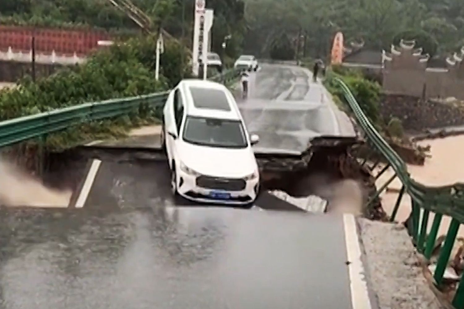 Car plunges into river before being swept away after broken bridge ...