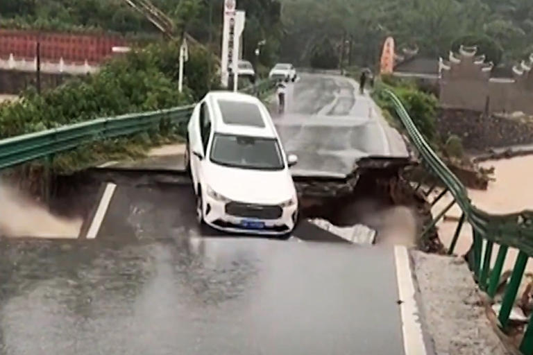 Car plunges into river before being swept away after broken bridge ...