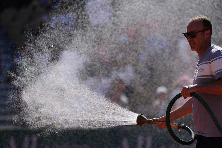 French Open groundskeepers drench the clay courts with water and salt ...