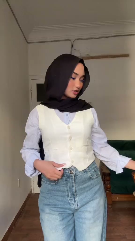 Styling a white vest with jeans for a modest hijab look
