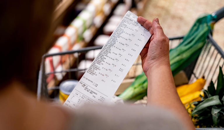 Woman compares grocery shopping receipt from 20 years ago