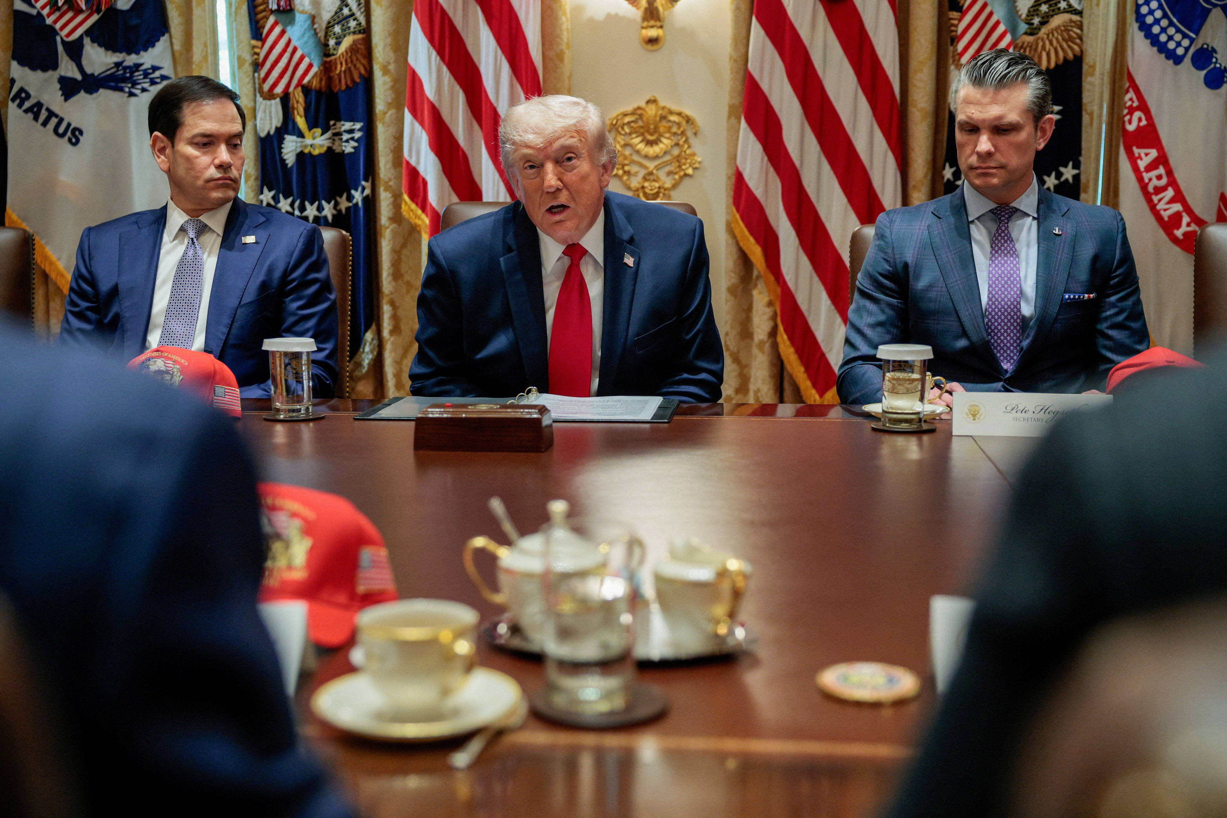 Trump slaps Hegseth arm and says 'he loves war' in Cabinet kickoff
