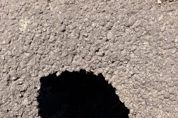 Warning issued after sinkhole appears on residential road