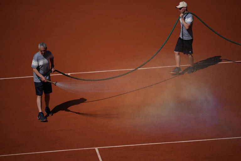French Open groundskeepers drench the clay courts with water and salt ...