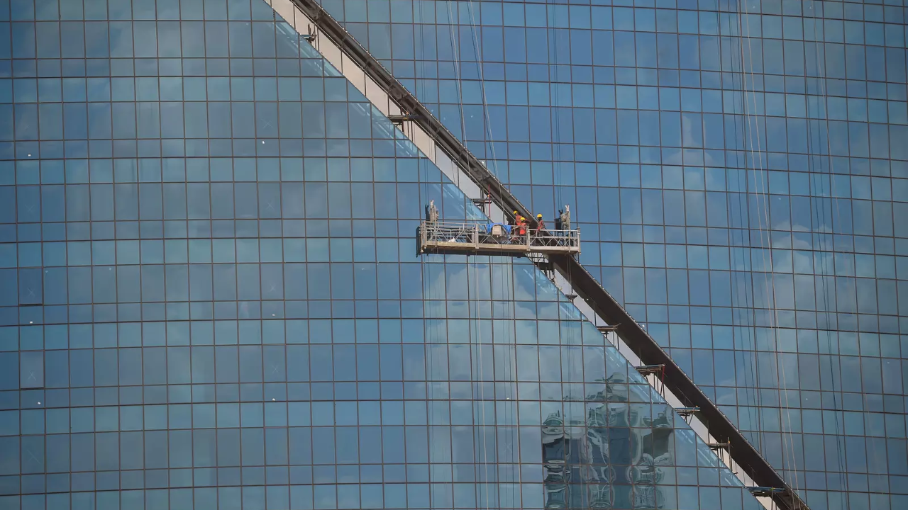 Why does India have glass buildings despite a hot climate?