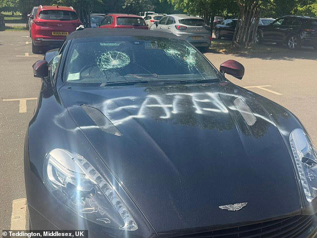 Masked vandal smashes windscreen of £250,000 Aston Martin before spray ...
