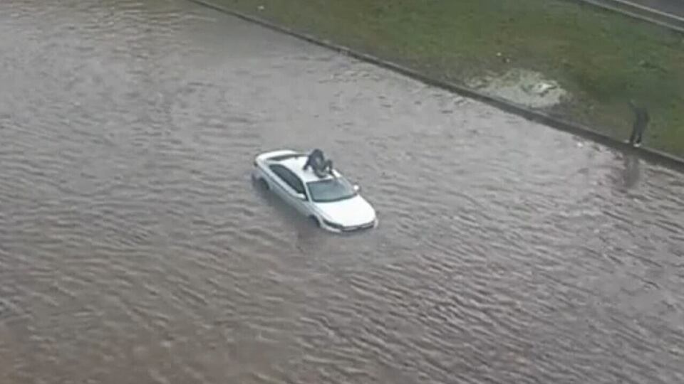 Woman recalls being stuck on top of her car in floodwater on I-85/75
