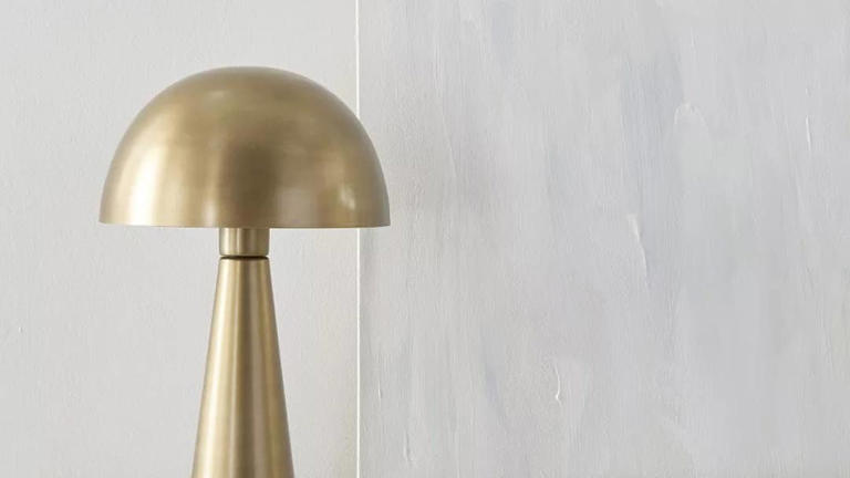 Target’s modern brass mushroom table lamp emits a soft, warm glow, and ...
