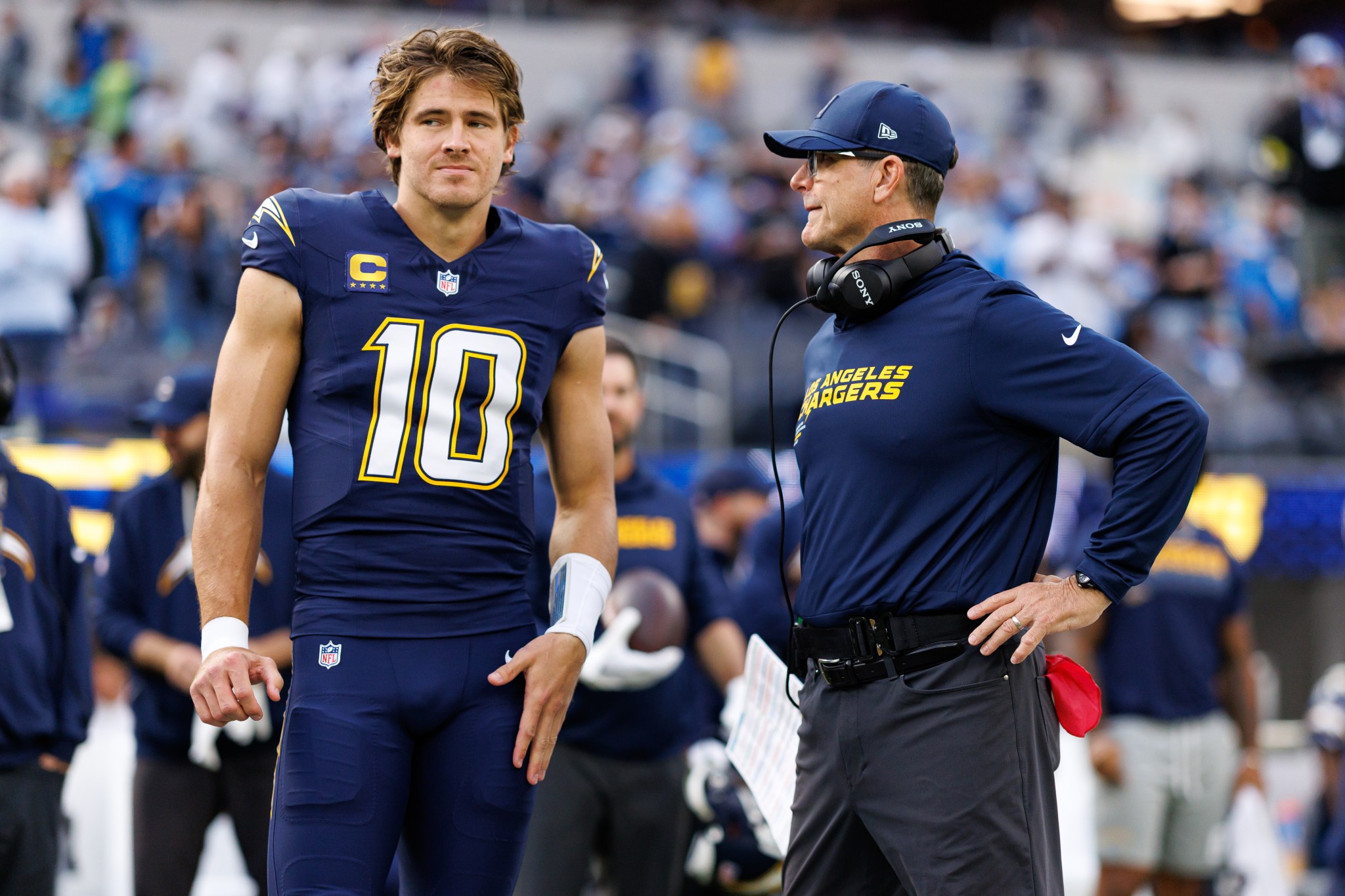 Jim Harbaugh downplays Justin Herbert missing workout for Madison Beer tour