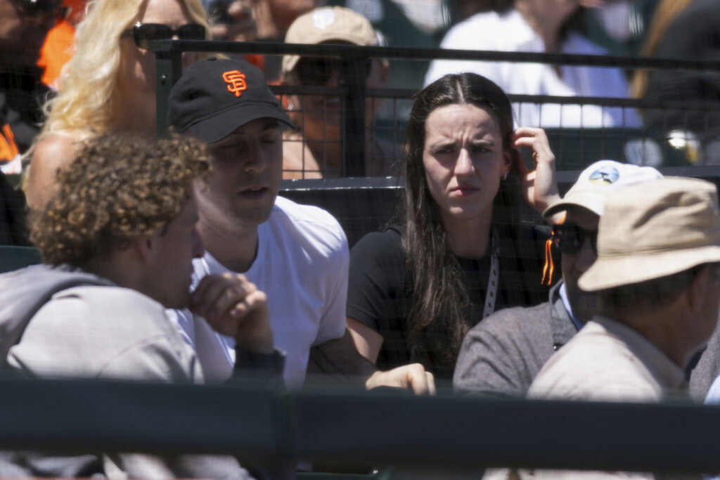 Caitlin Clark swaps hardwood for owners’ box luxury alongside Connor ...