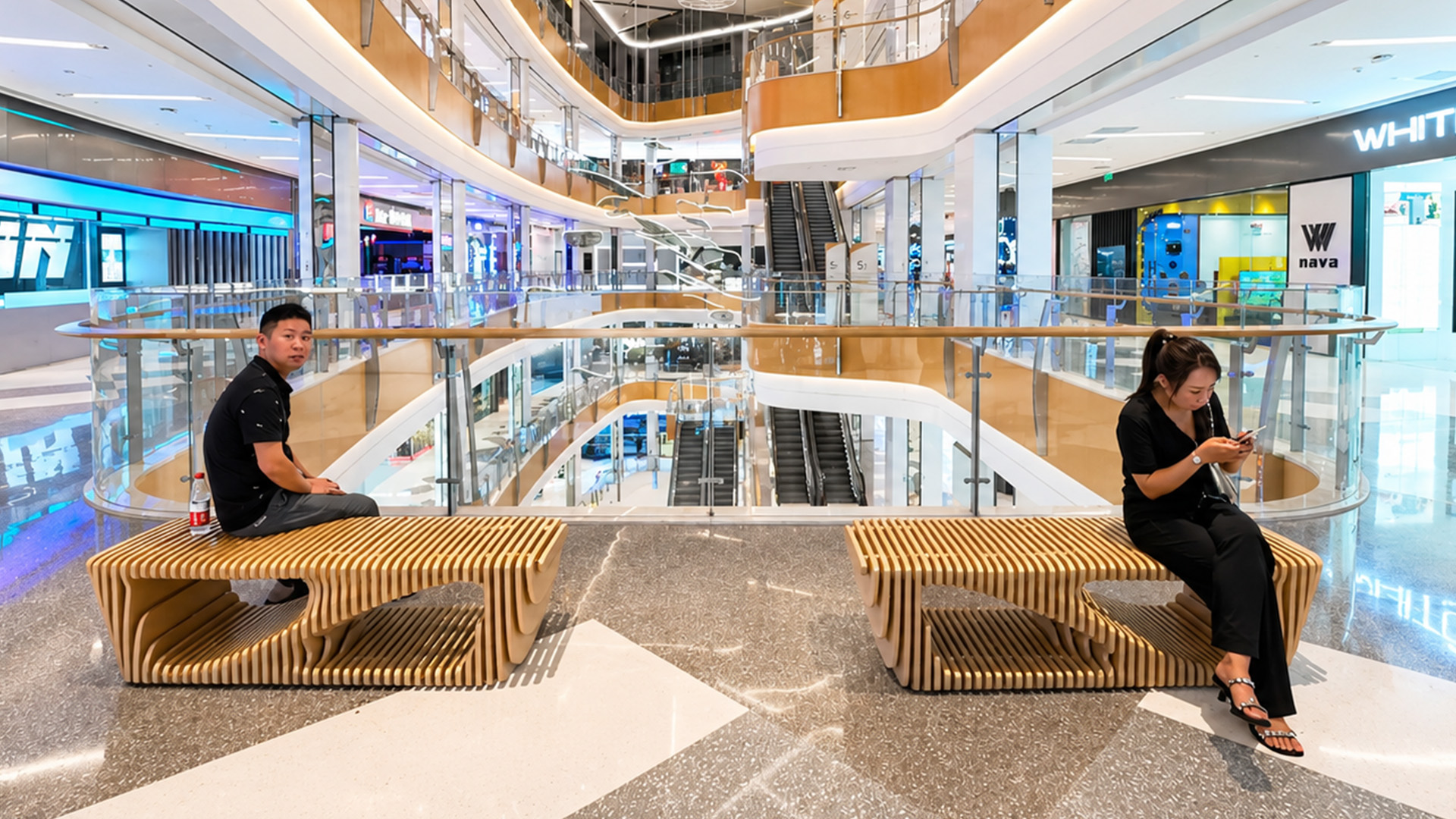 Visitors pause inside this spacious multi floor shopping complex