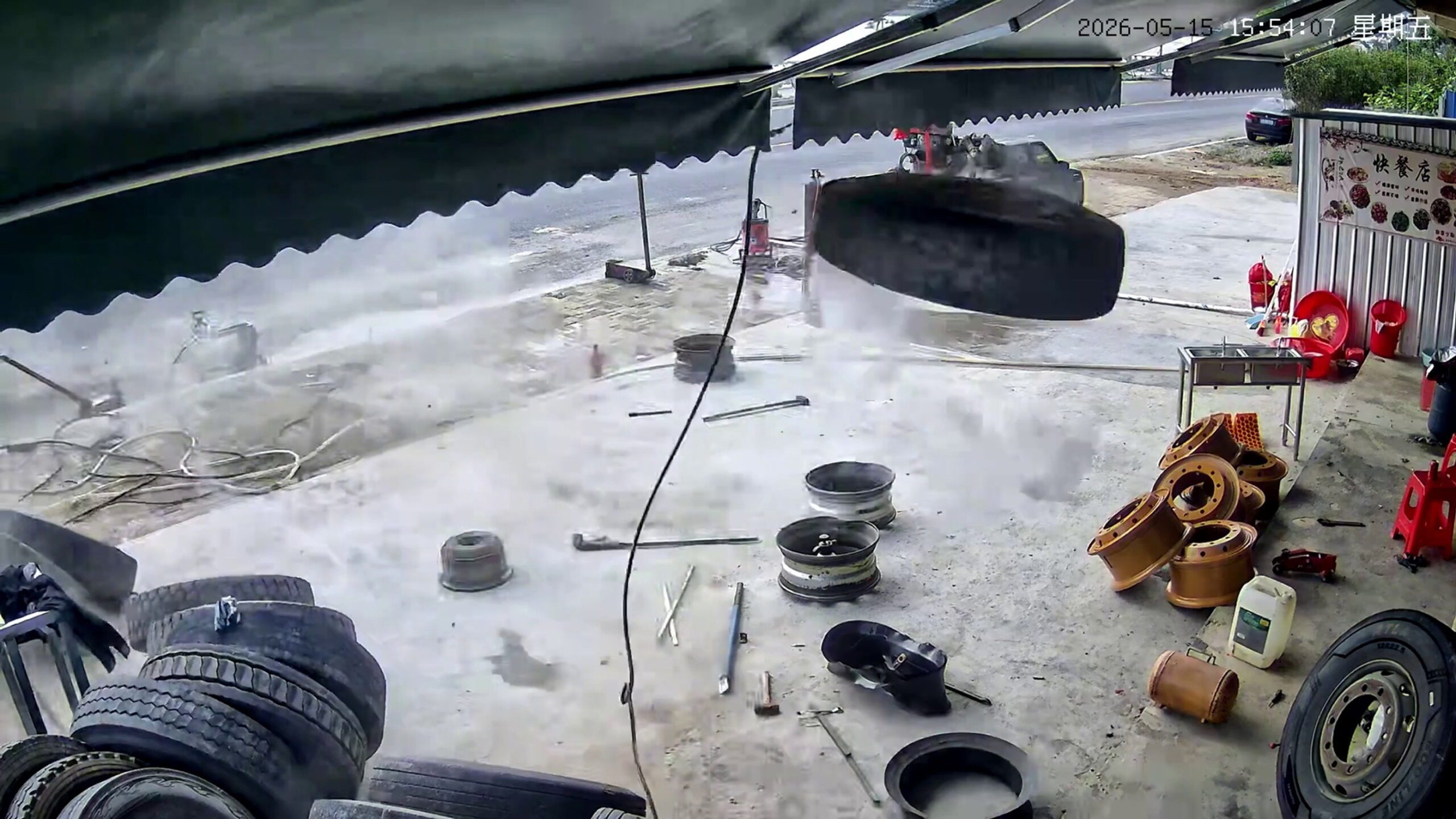 Car tyre shoots into the air – narrowly missing shop owner
