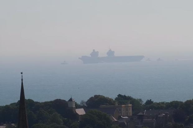 UK's largest warship HMS Queen Elizabeth spotted through the haze off Ryde