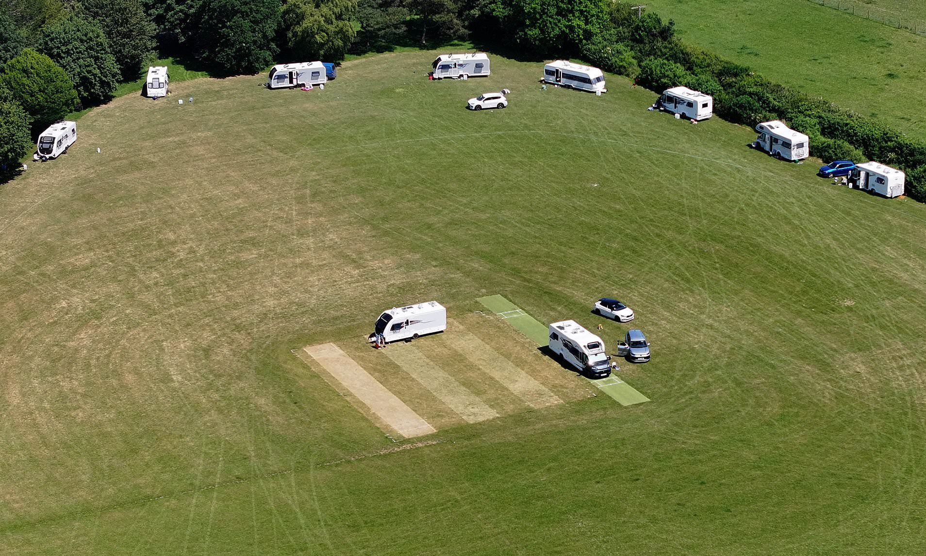 Travellers take over village cricket ground and spark fury by parking ...
