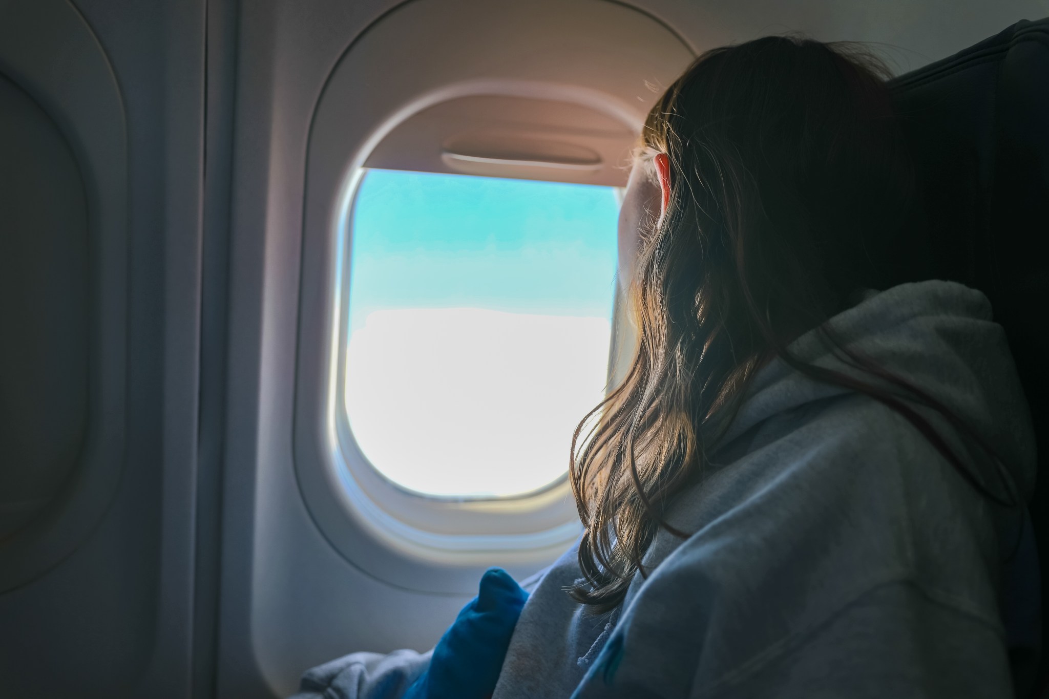 Woman looks out plane window mid-flight—can't explain what she sees in sky