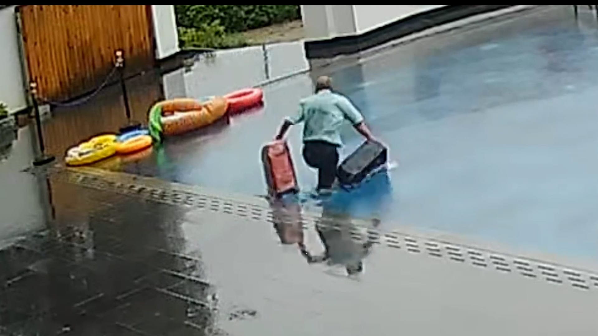 Hotel porter walks straight into swimming pool after failing to notice ...