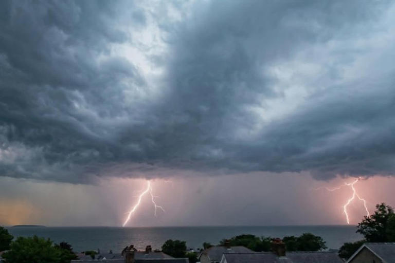 'Pink lightning' fills North Wales sky as Anglesey 'disappears' on ...