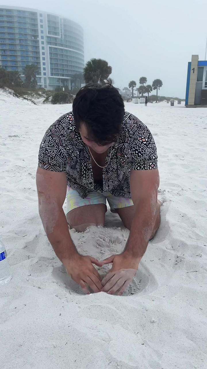 Emotional Surprise of Making a Heart in Sand With Hands