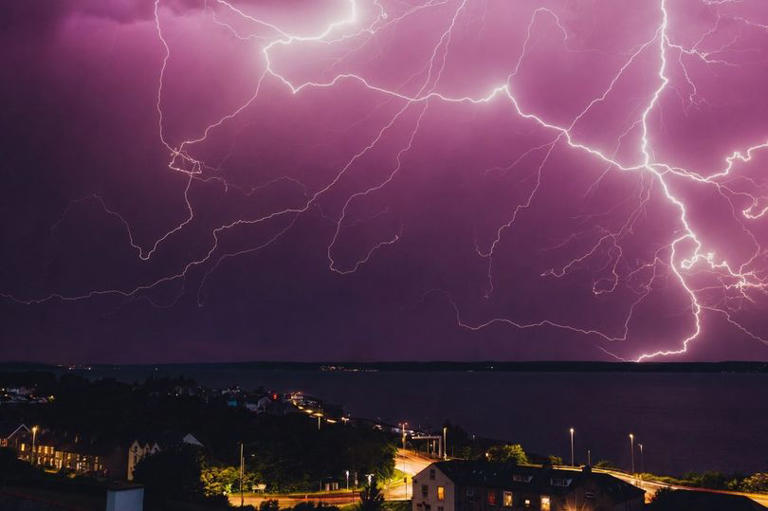 'Pink lightning' fills North Wales sky as Anglesey 'disappears' on ...