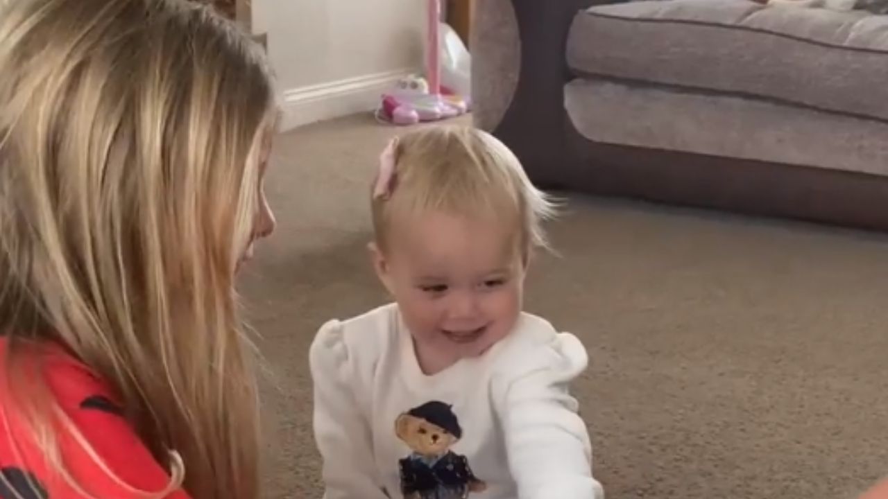 Adorable toddler wears her elation on her sleeve while meeting family doggo