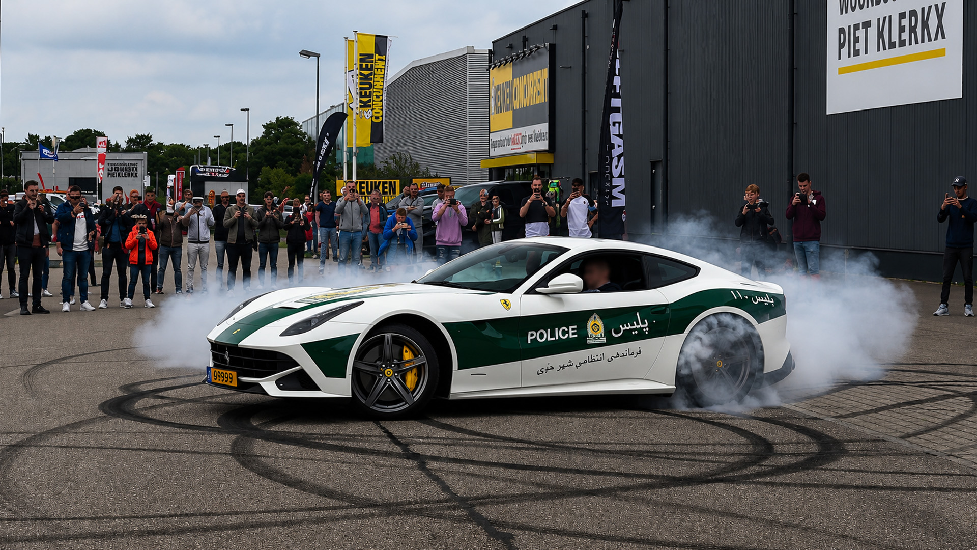 A police Ferrari makes donuts in front of crowd