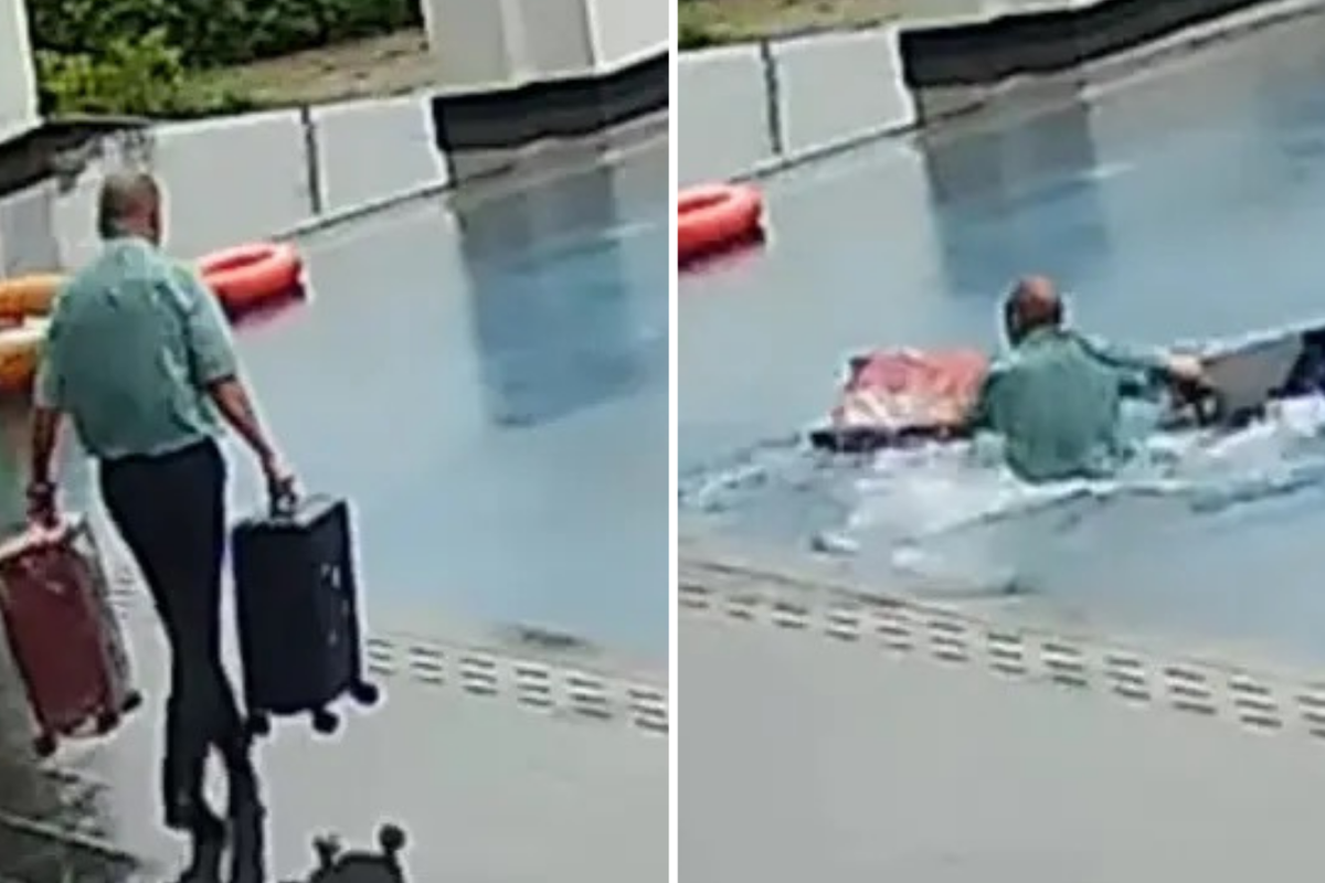 Moment unaware hotel porter falls straight into swimming pool