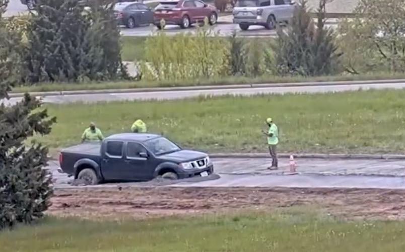 Driver ignores road closure, gets stuck in wet concrete