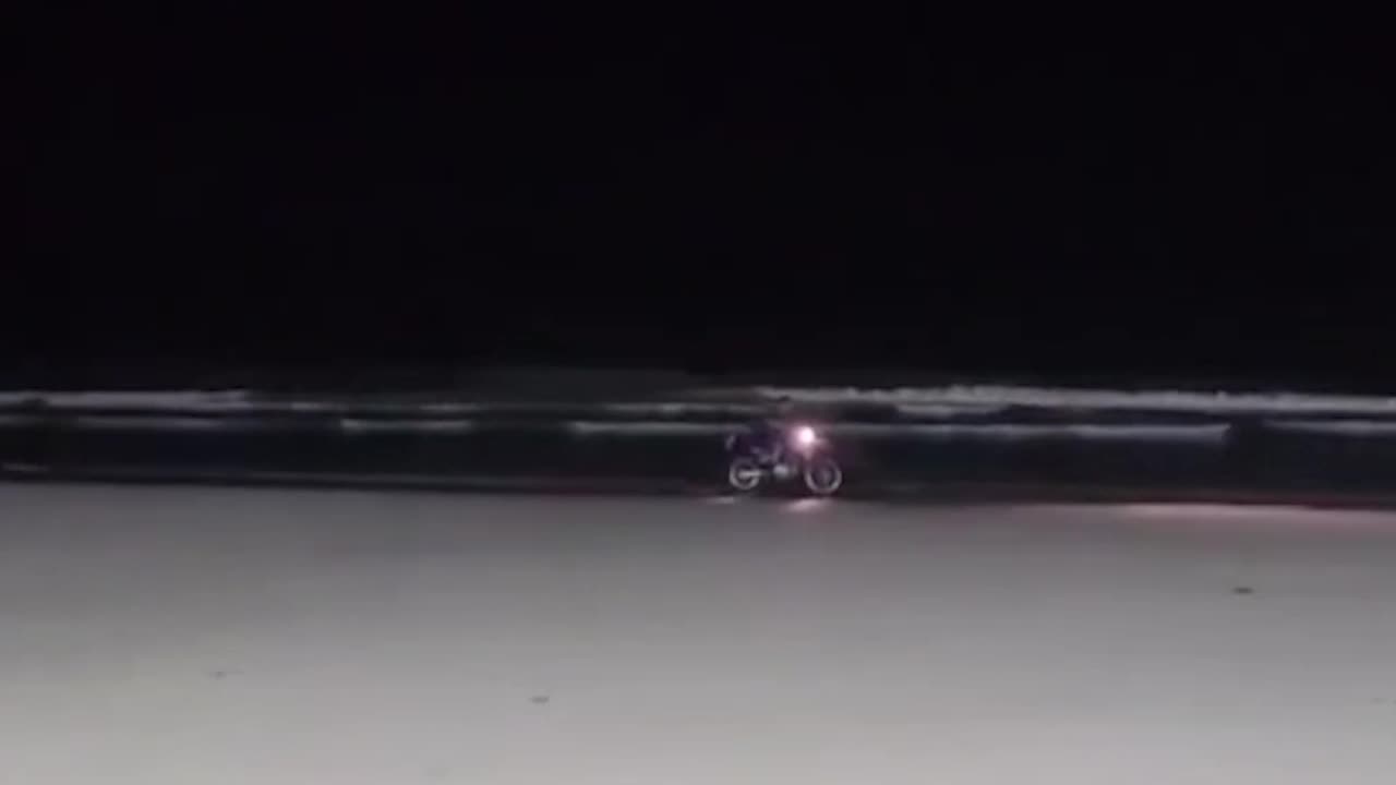 Tourist caught speeding motorcycle across beach before bike gets stuck ...