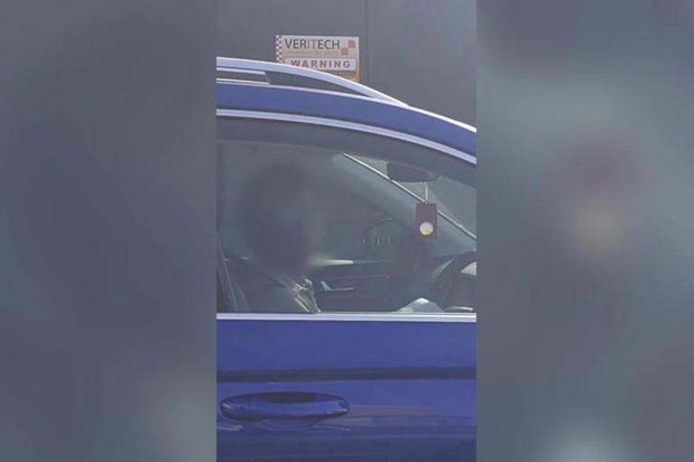 Driver paying for parking ticket behind wheel is caught red-handed