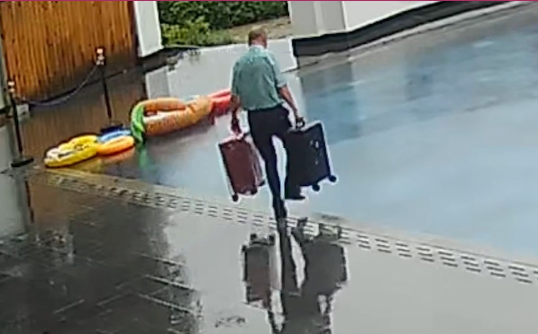 Hotel porter walks straight into swimming pool after failing to notice ...