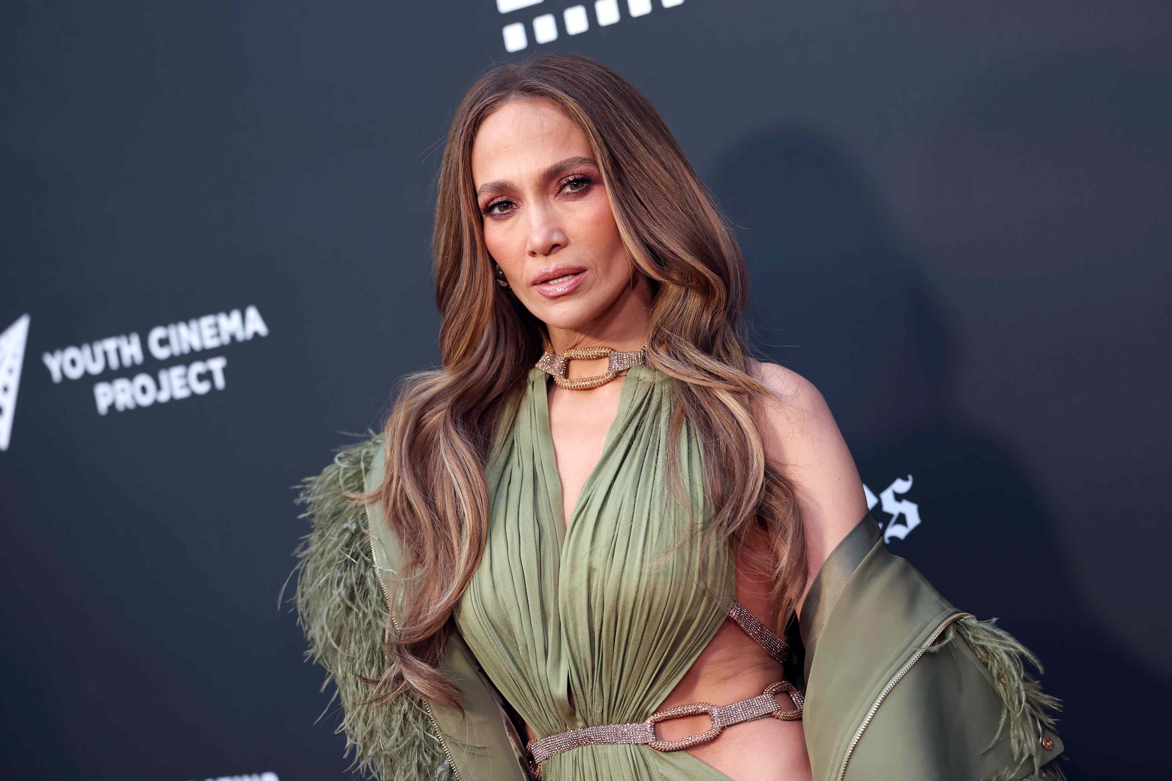 Jennifer Lopez's body-baring olive green gown is literally held ...
