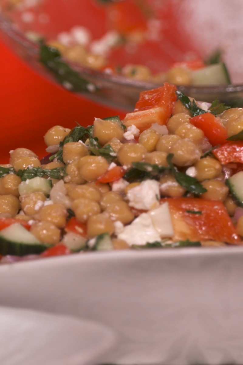 Creamy chickpea salad with cucumbers peppers and herbs
