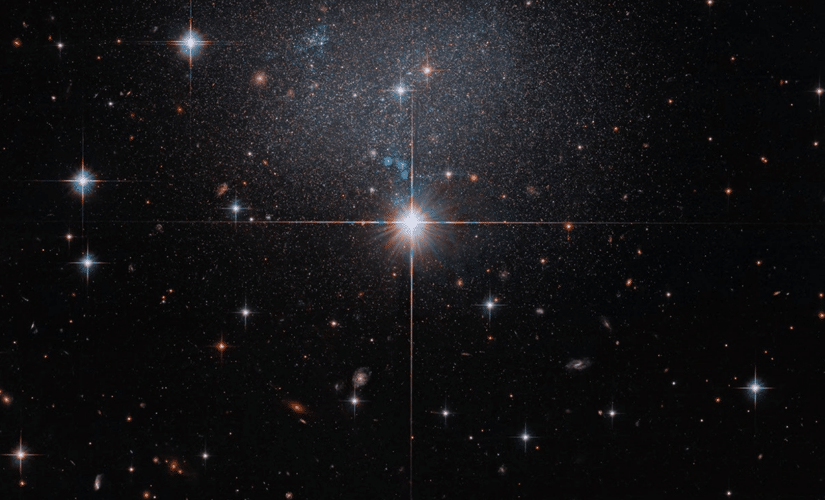 Hubble reveals hidden dwarf galaxy illuminating cosmic flows