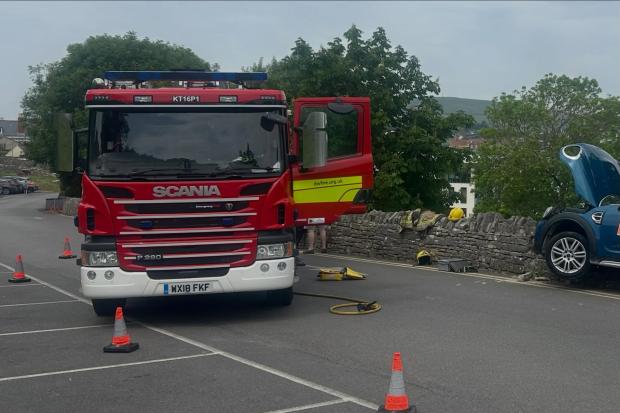 Car 'drives through stone wall' near car park