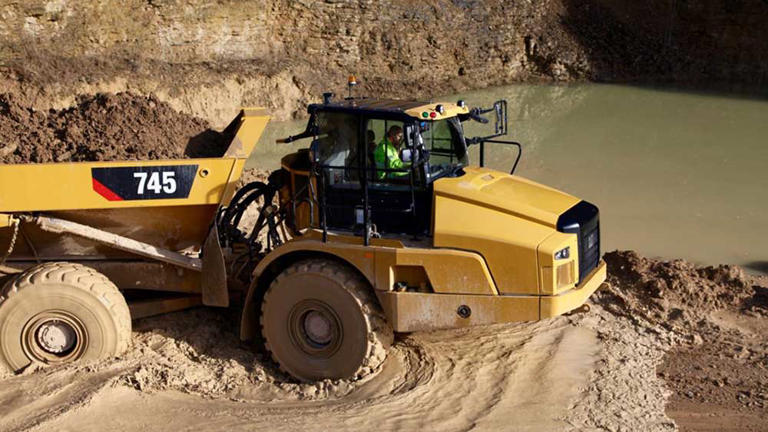 CAT stock hikes dividend 8%, leads Dow Jones rebound