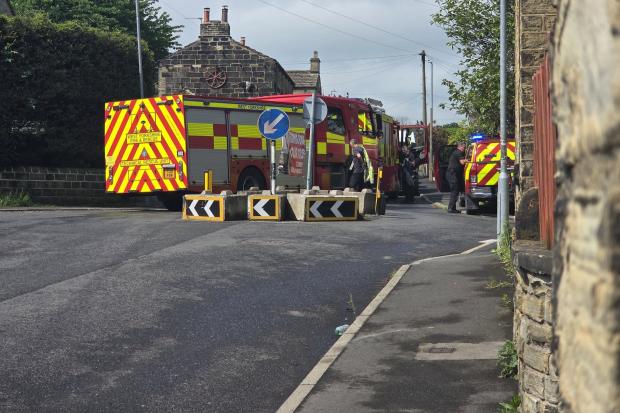 Woman rescued from car after crash where vehicle flipped on its side
