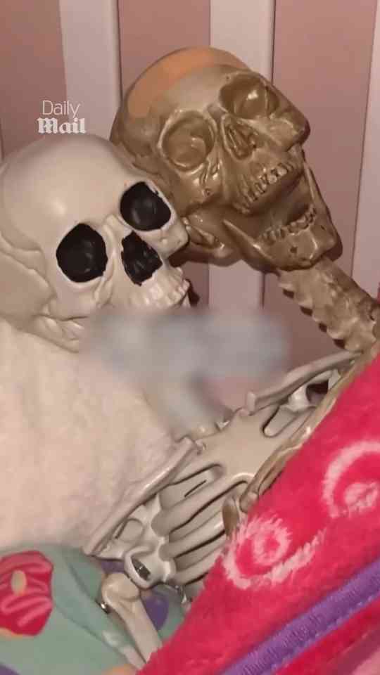 Little girl adorably obsessed with sleeping beside skeleton decorations